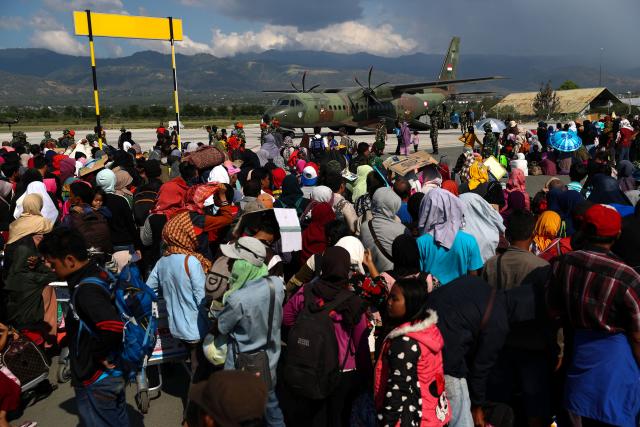 Indonesian survivors desperate to flee disaster zone as death toll ...