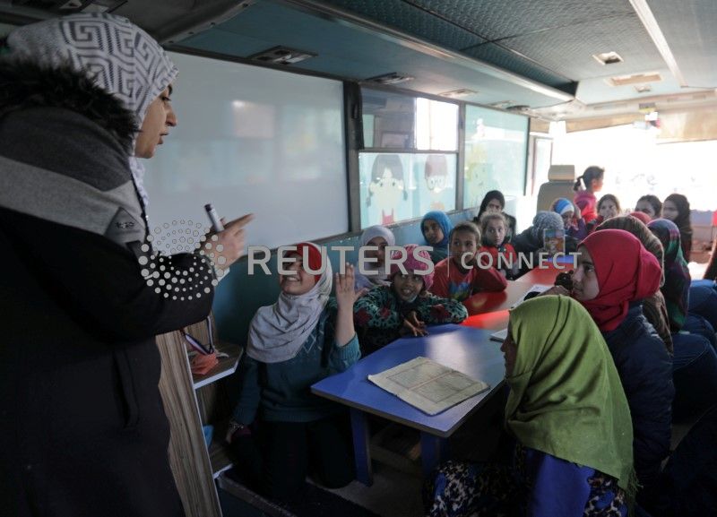 Having fled bombing, Syrian children learn to read in borderland tent ...