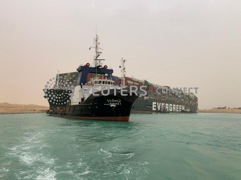 Tugs work to free giant container ship stranded in Suez Canal - The ...