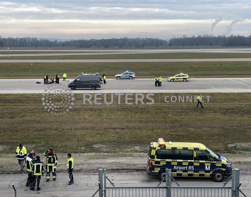 Climate activists glue themselves to airport tarmac in Berlin and ...